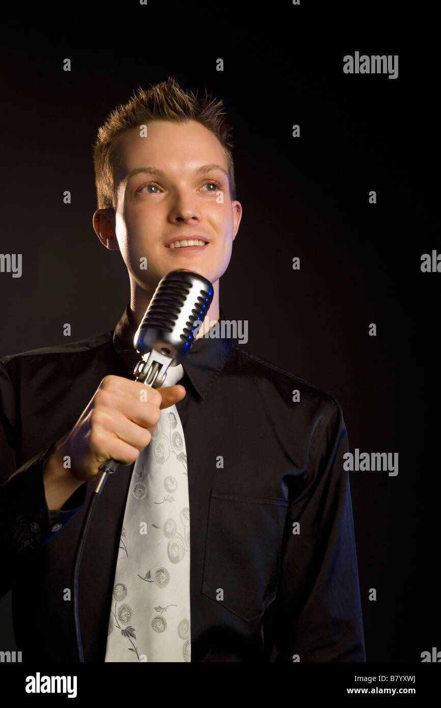 Young man with a microphone Stock Photo - Alamy