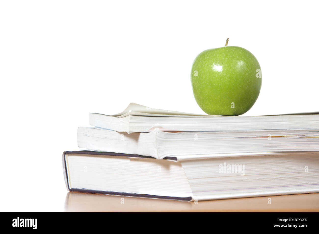 An apple on top of a stack of books Stock Photo - Alamy