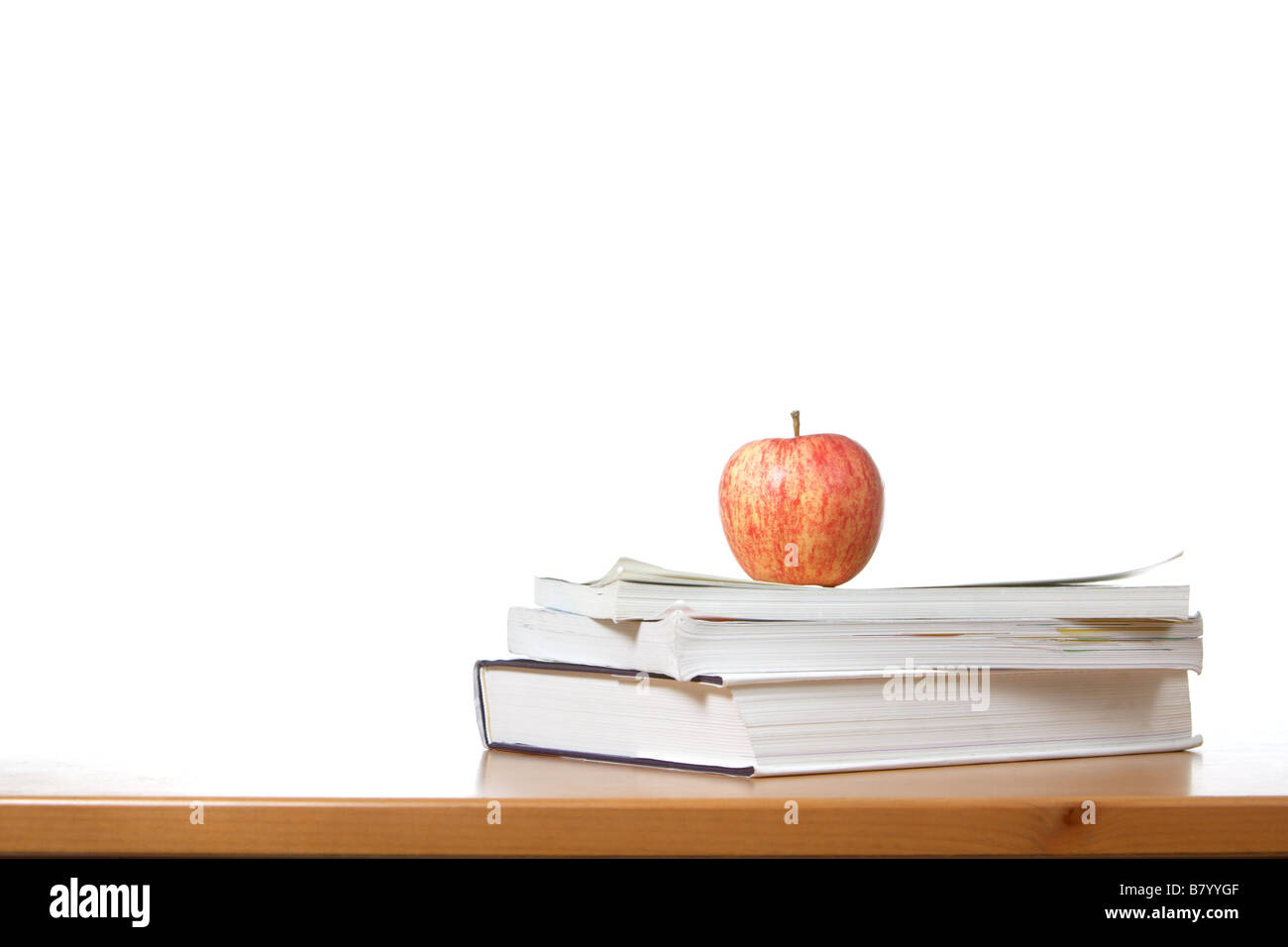 An apple on top of a stack of books Stock Photo - Alamy