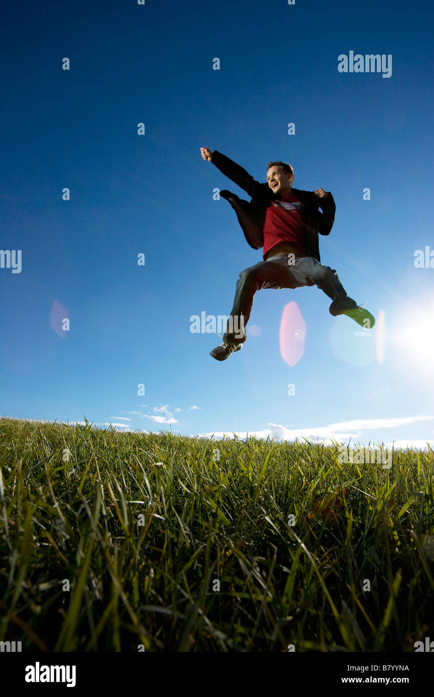 Young man jumping Stock Photo - Alamy