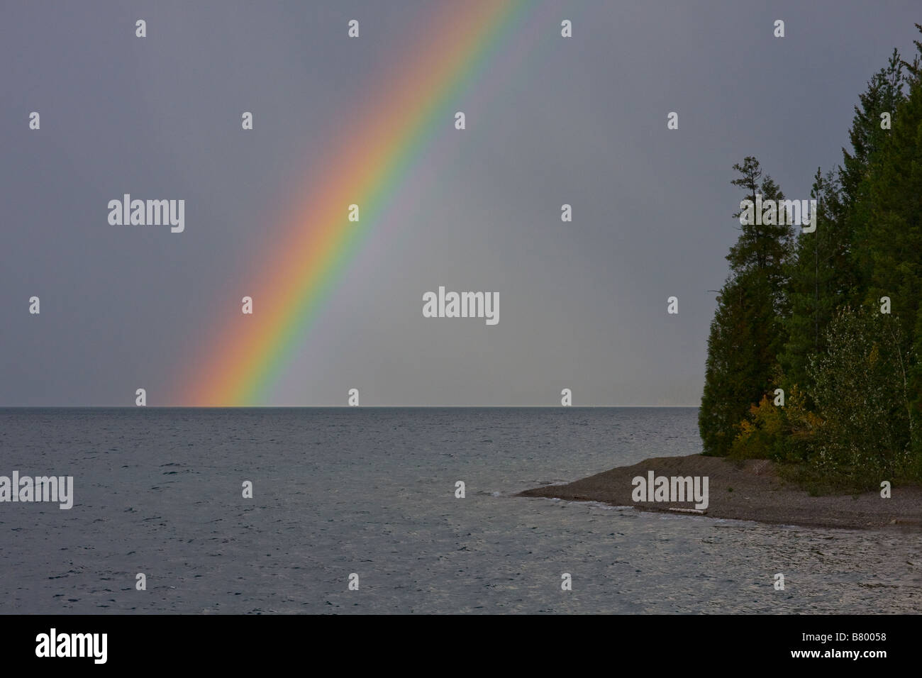 Rainbow over lake Stock Photo - Alamy