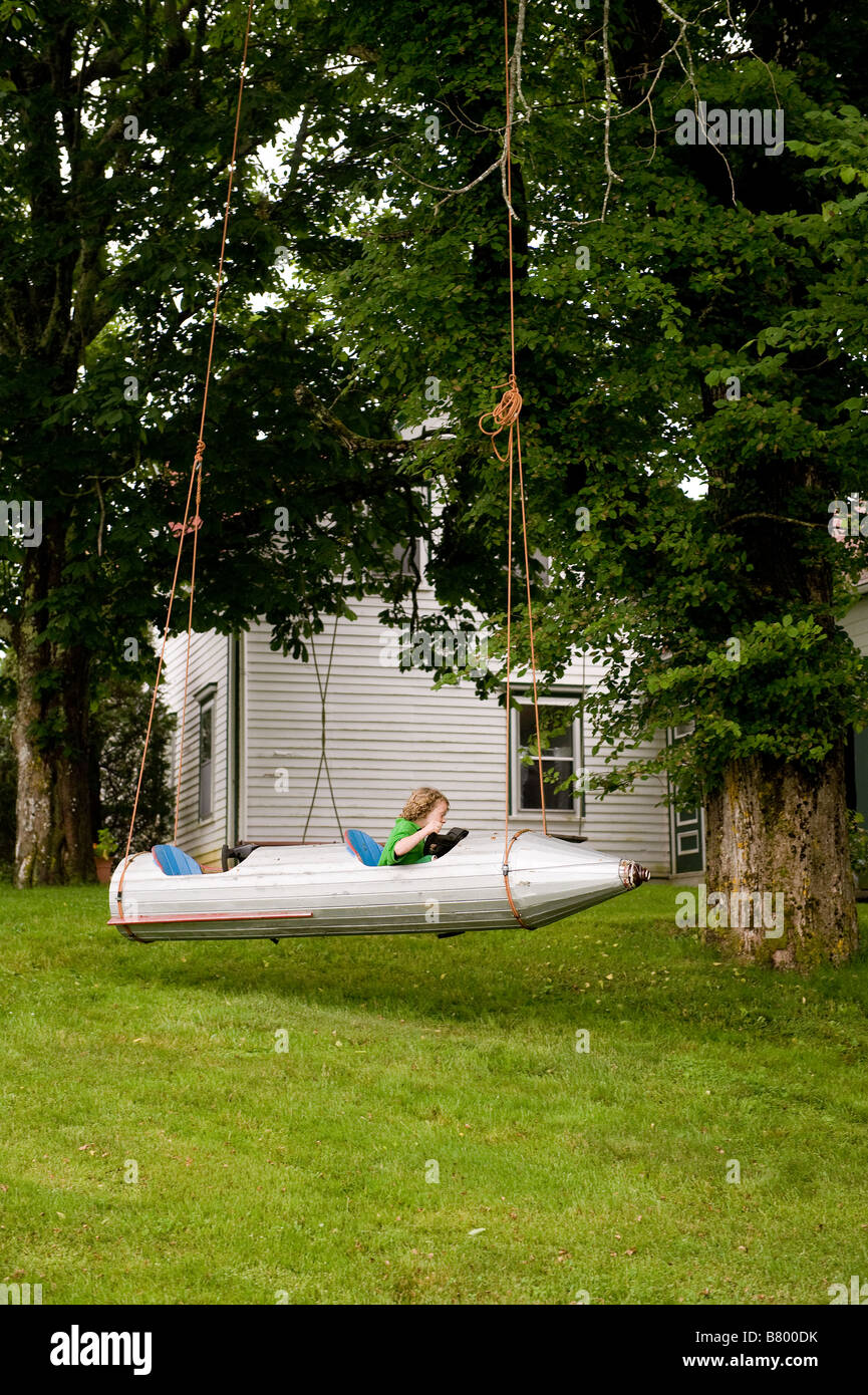A young boy pretends to fly in a swing space ship Stock Photo - Alamy