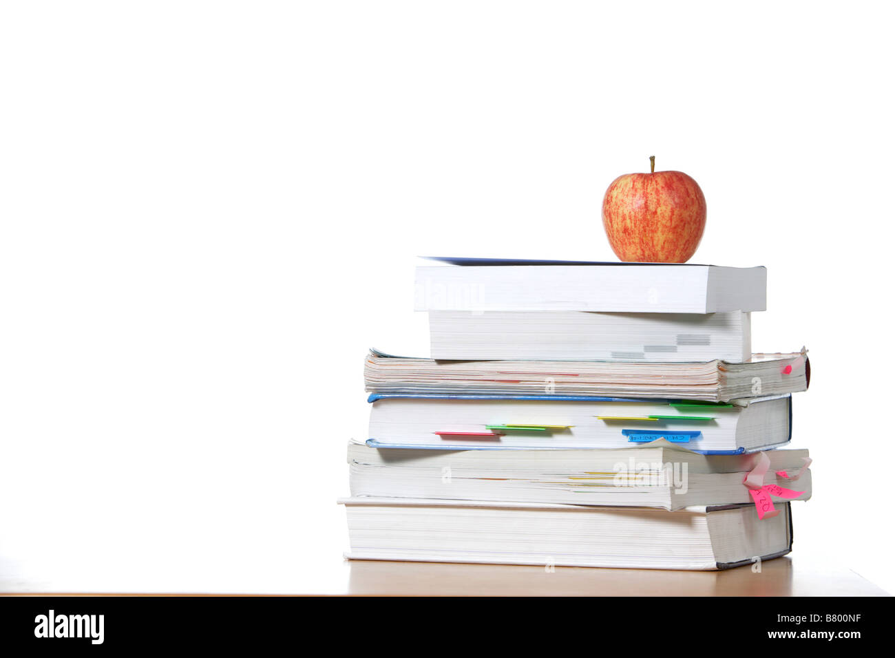 An apple on top of a stack of books Stock Photo - Alamy
