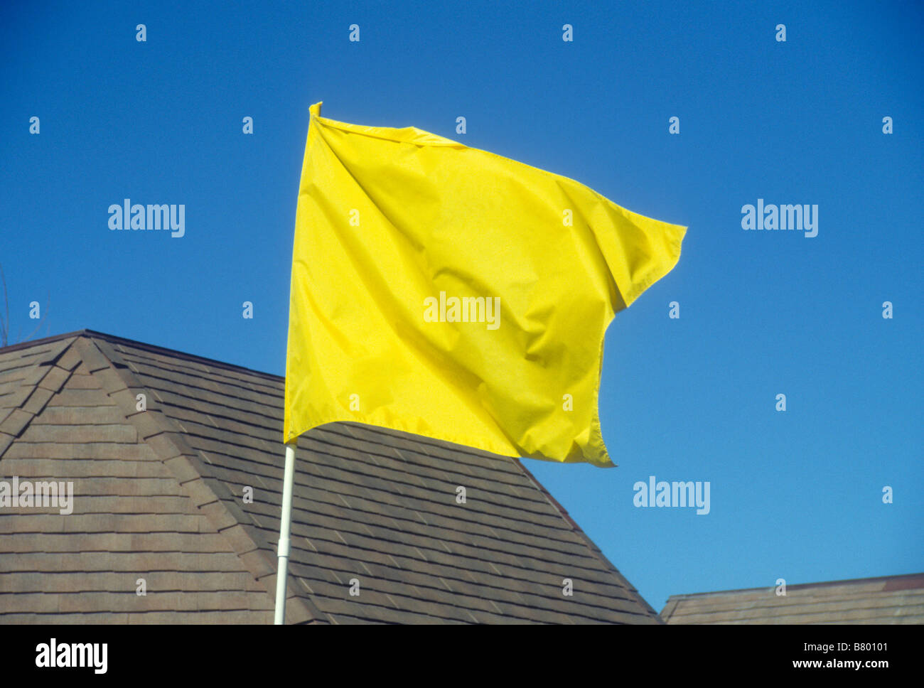 Yellow flag blows in the wind flap attention market sell sale promotion ...