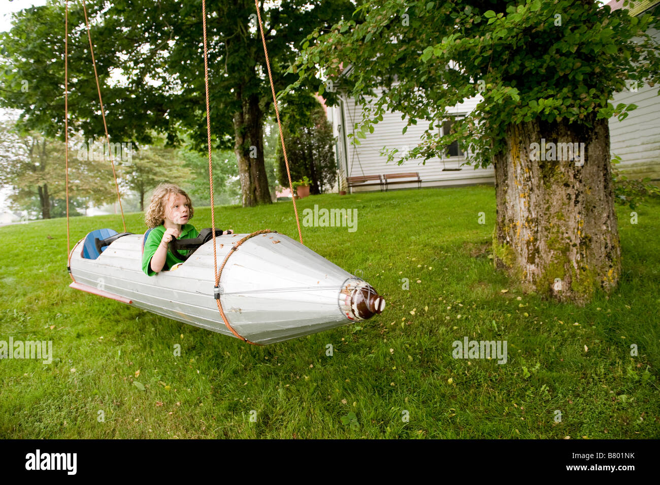 A young boy plays in a swing built as a spaceship Stock Photo - Alamy