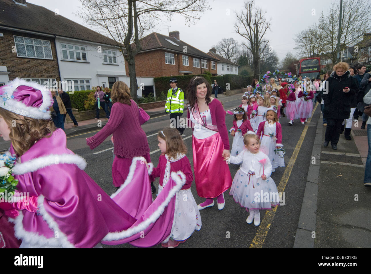 Girls in costumes in May Queen procession on surburban street in South ...