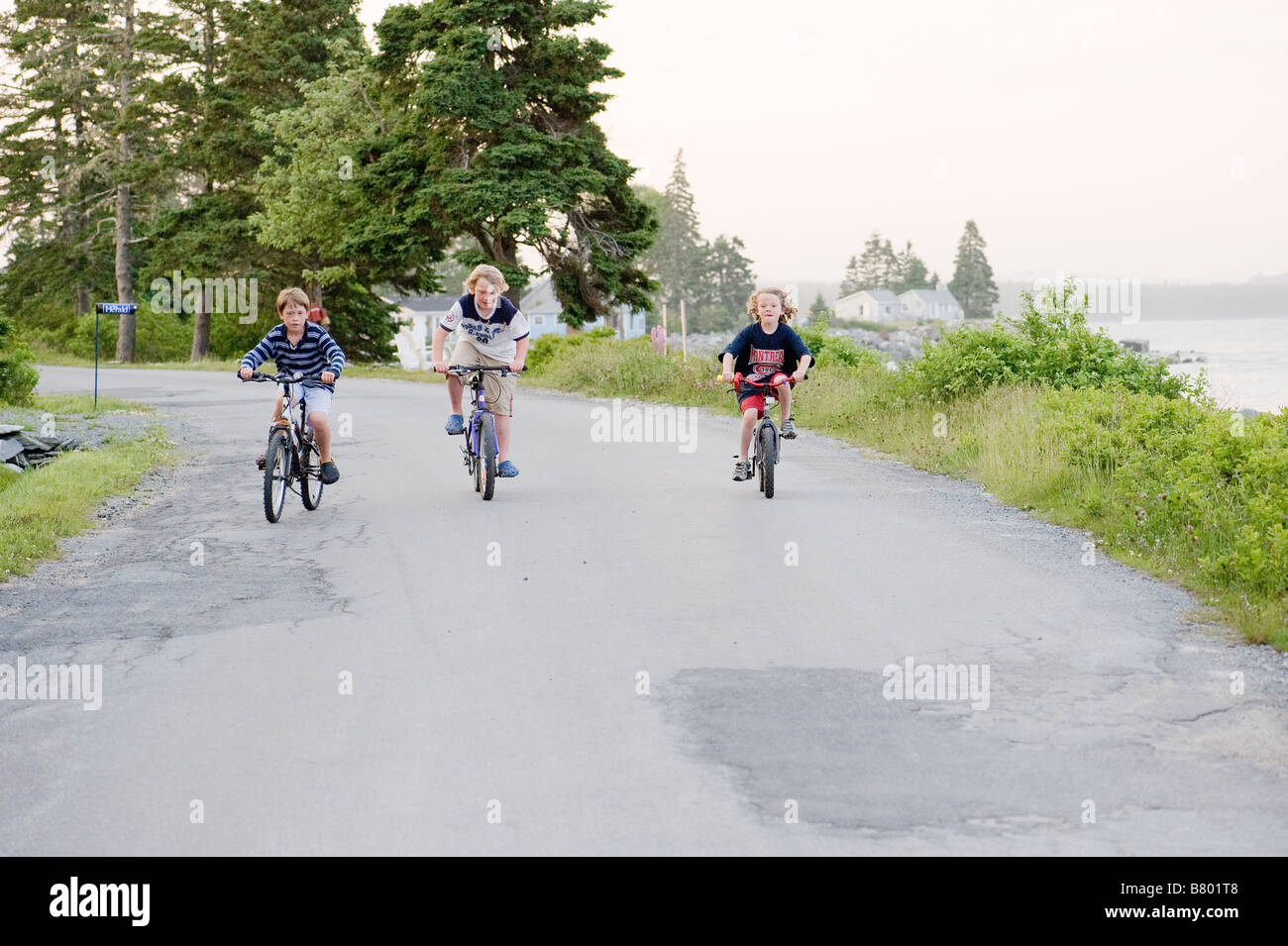 Kids riding their bikes together Stock Photo - Alamy