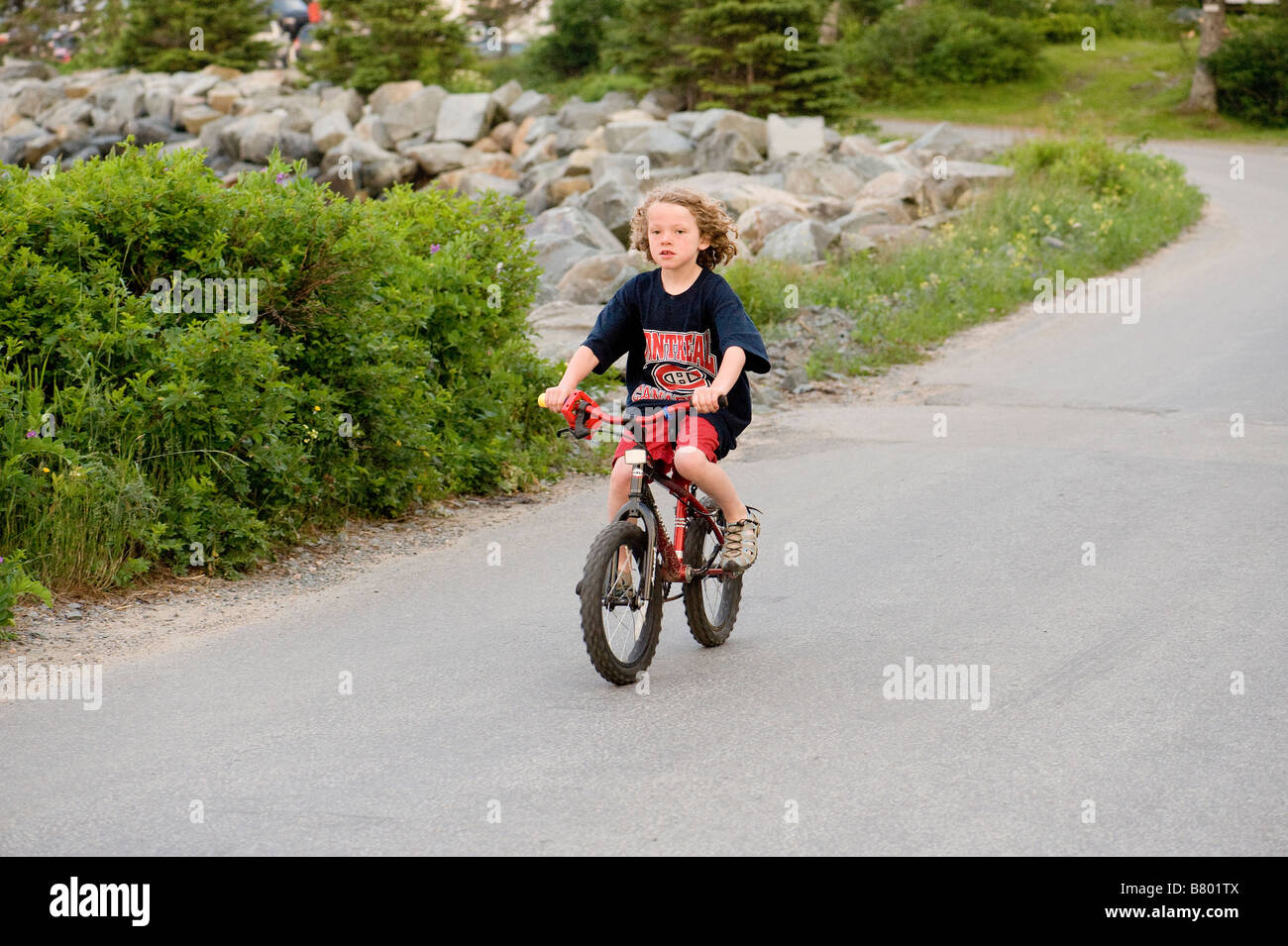A child riding a bike at his cottage Stock Photo - Alamy