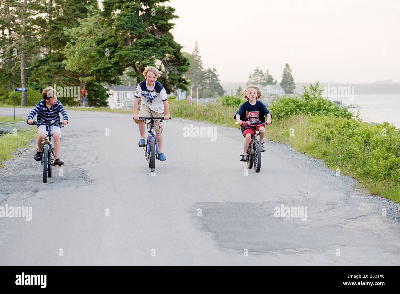 Kids riding their bikes together Stock Photo - Alamy