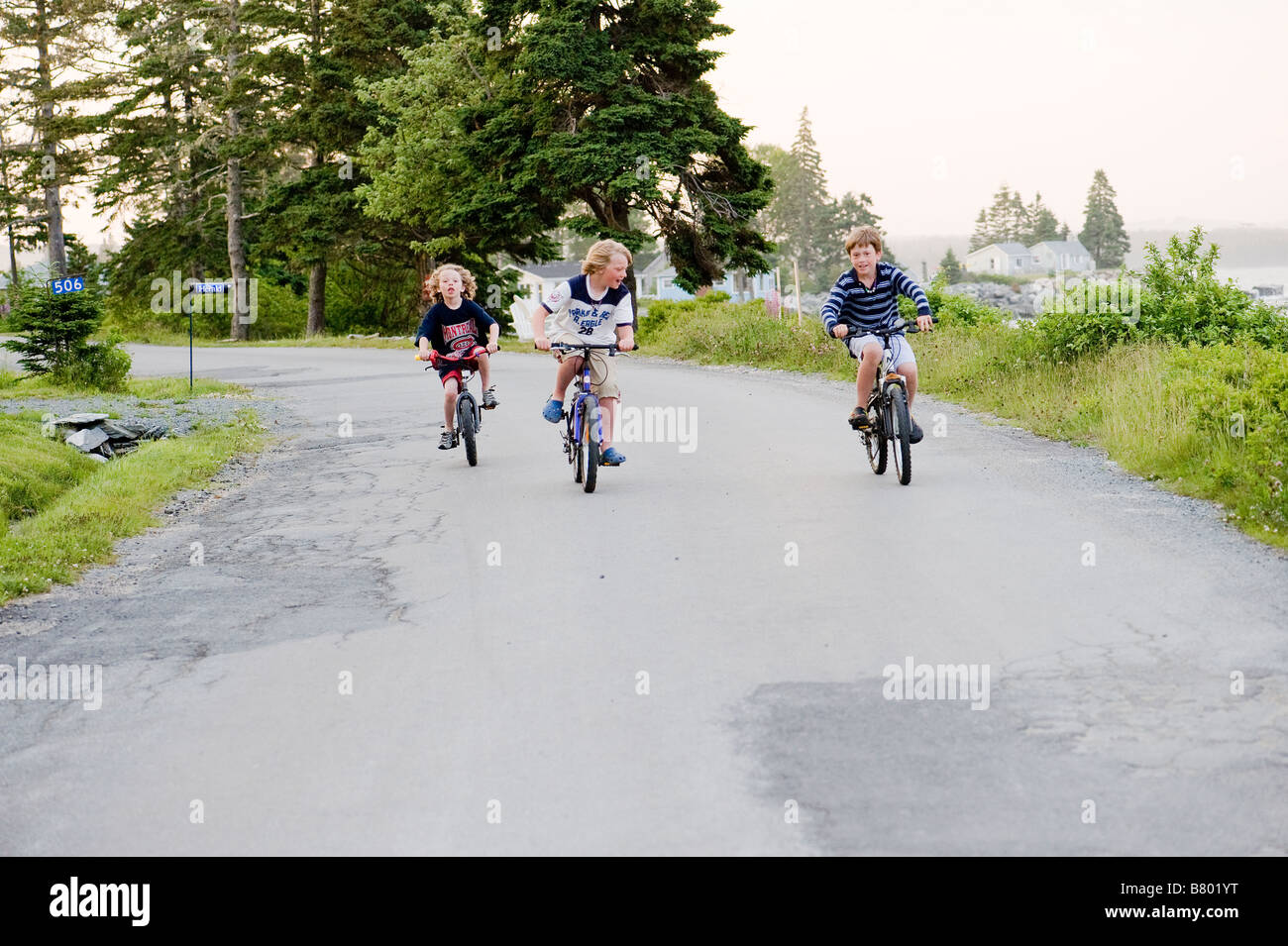 Kids riding their bikes together Stock Photo - Alamy