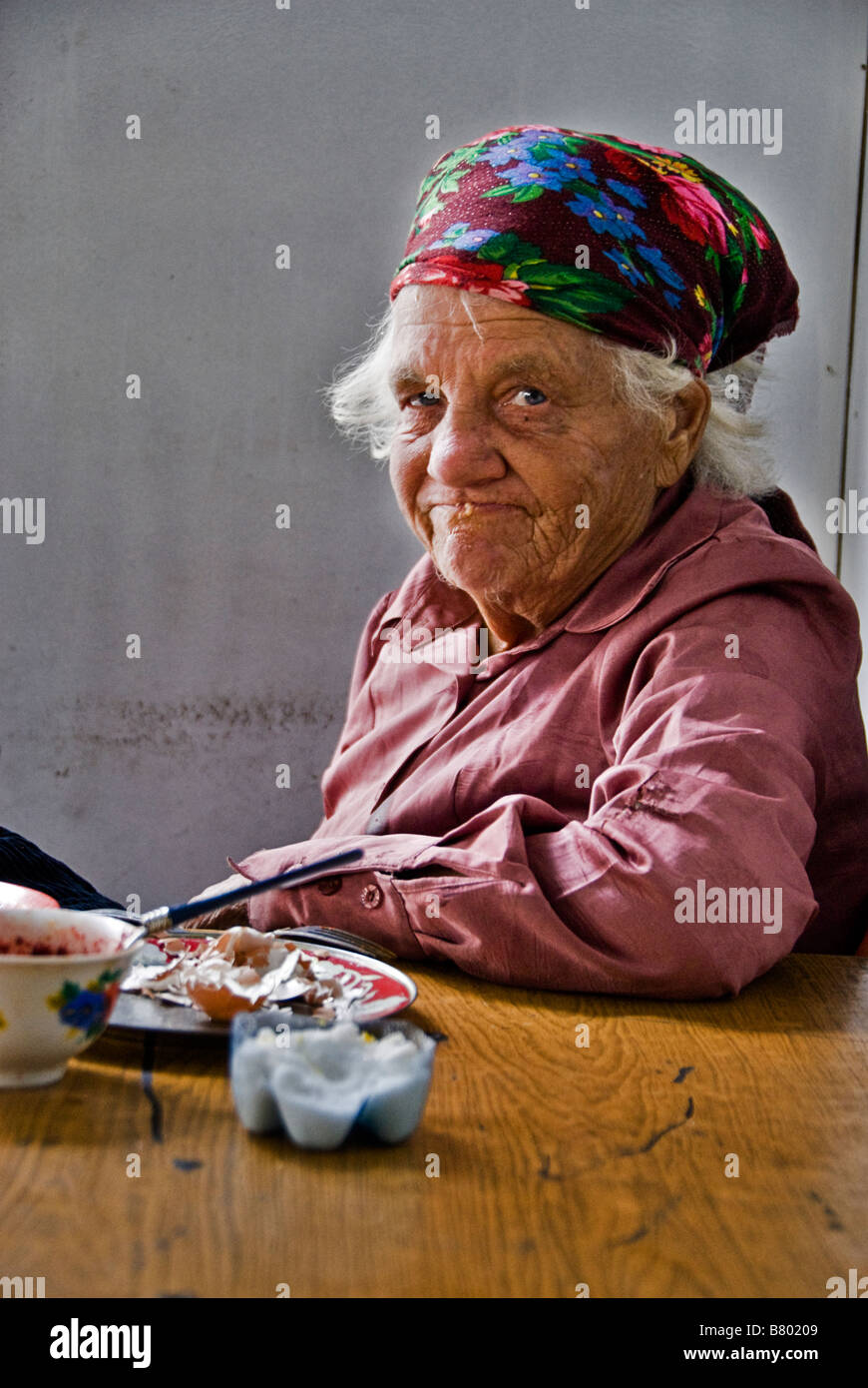 Old poor woman eating in a food stall Bishkek Kyrgyzstan Stock Photo ...