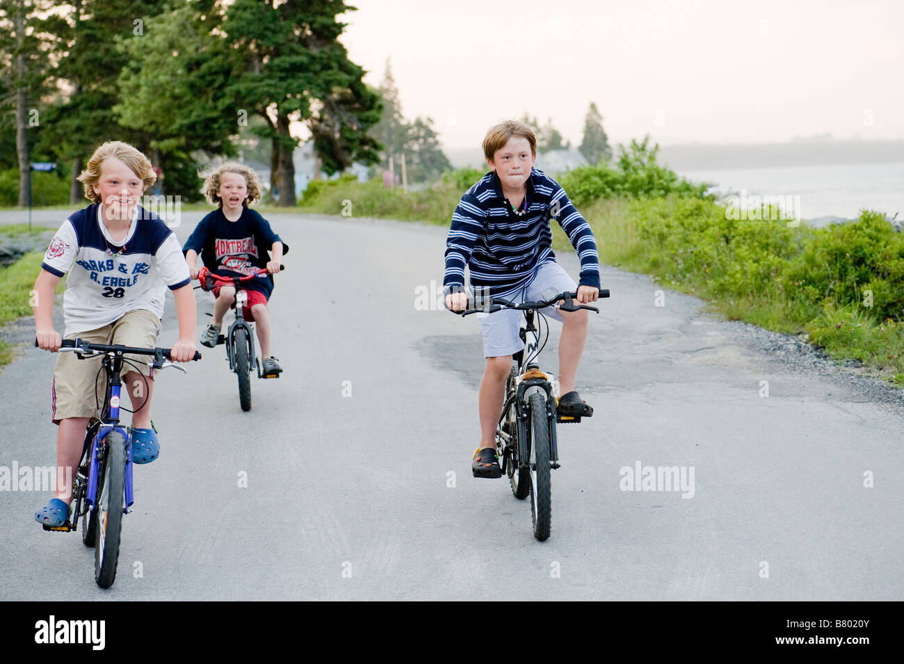 Kids riding their bikes together Stock Photo - Alamy
