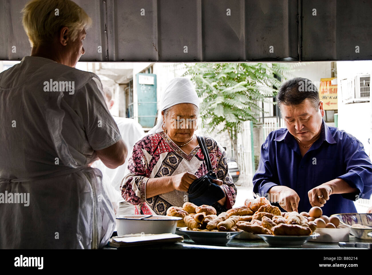People buying fast food in a food stall near osh bazar Bishkek ...