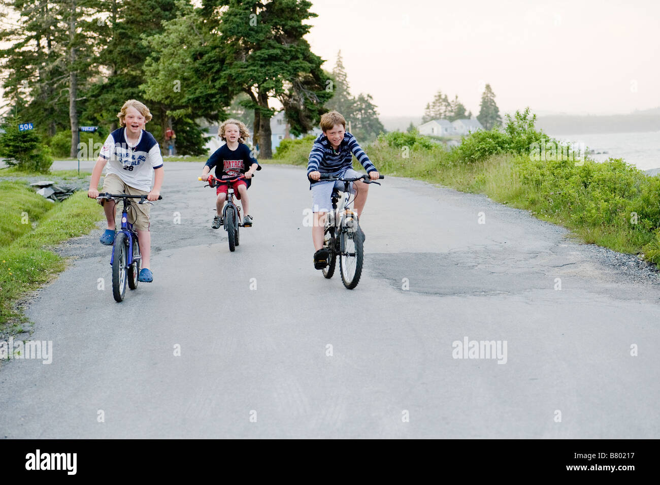 Kids riding their bikes together Stock Photo - Alamy