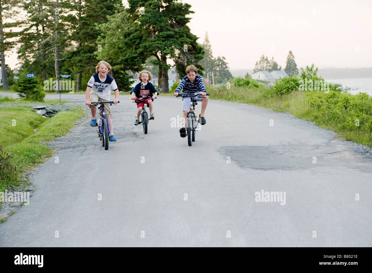 Kids riding their bikes together Stock Photo - Alamy