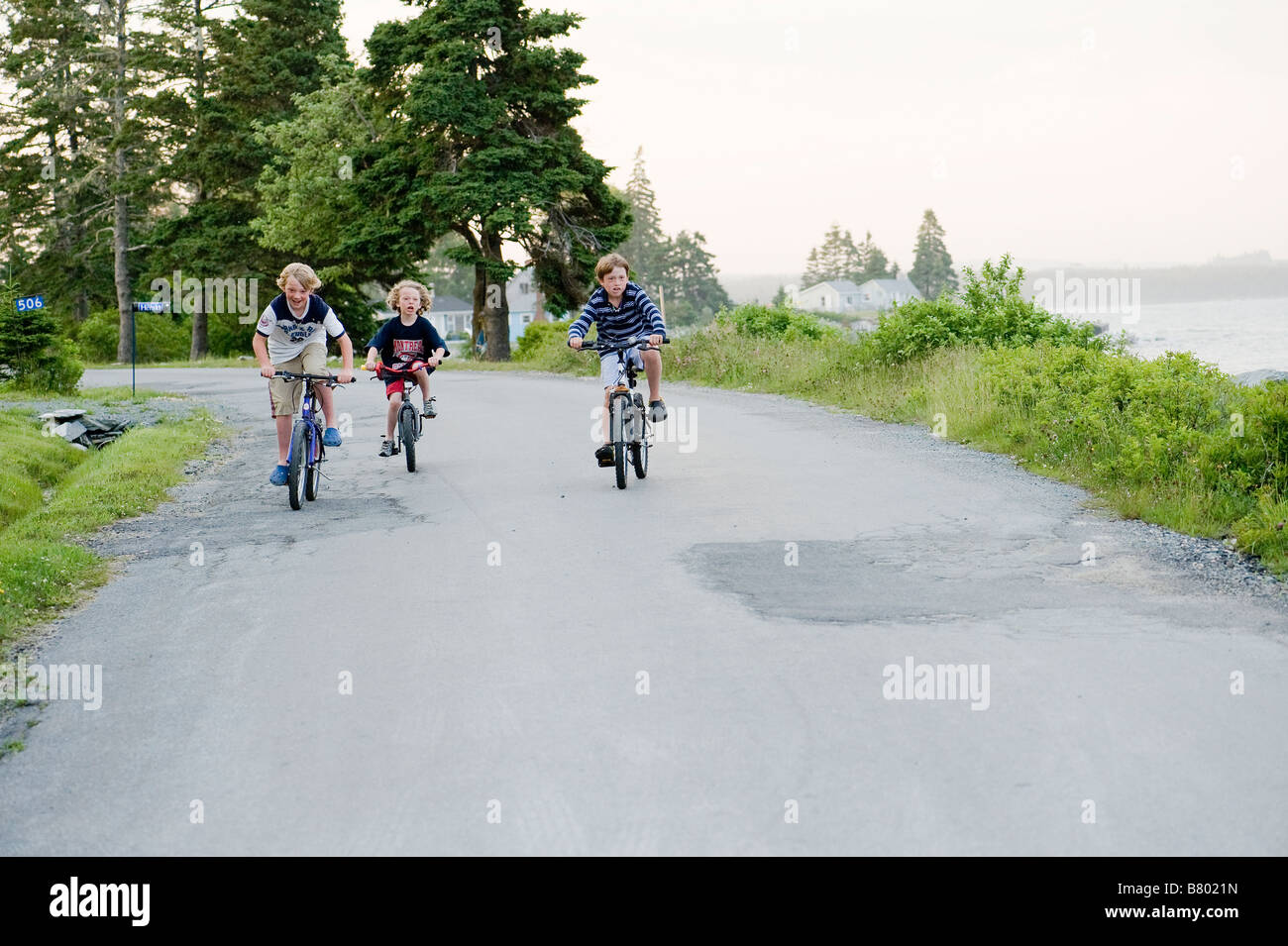 Kids riding their bikes together Stock Photo - Alamy