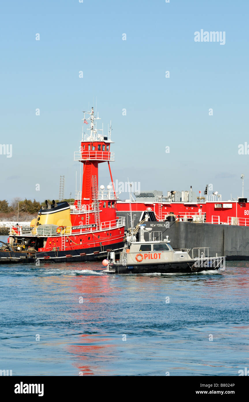 Red tugboat and barge from "Bouchard transportation" Company with ...