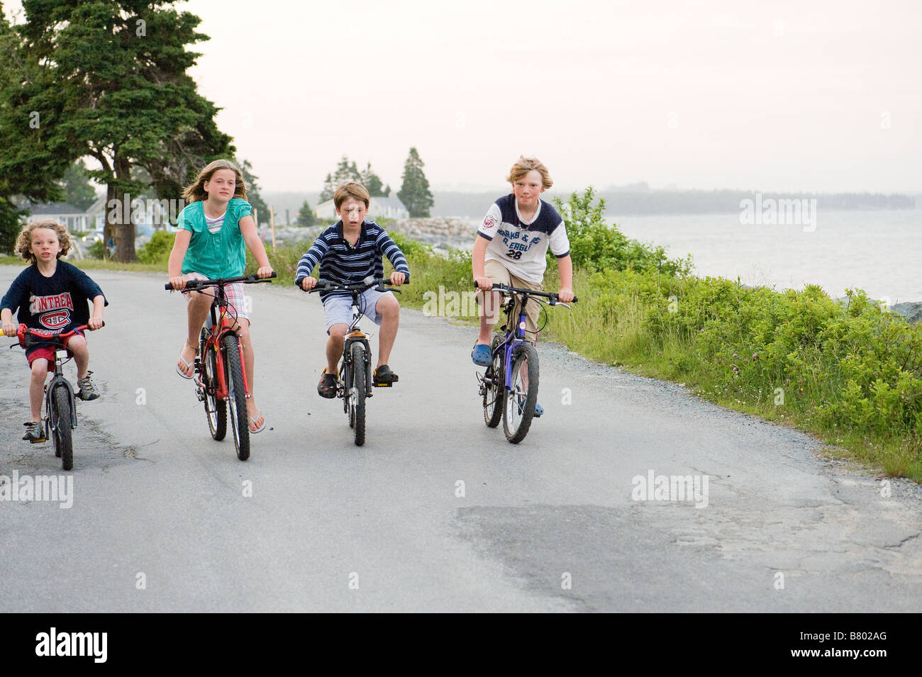 Kids riding their bikes together Stock Photo - Alamy