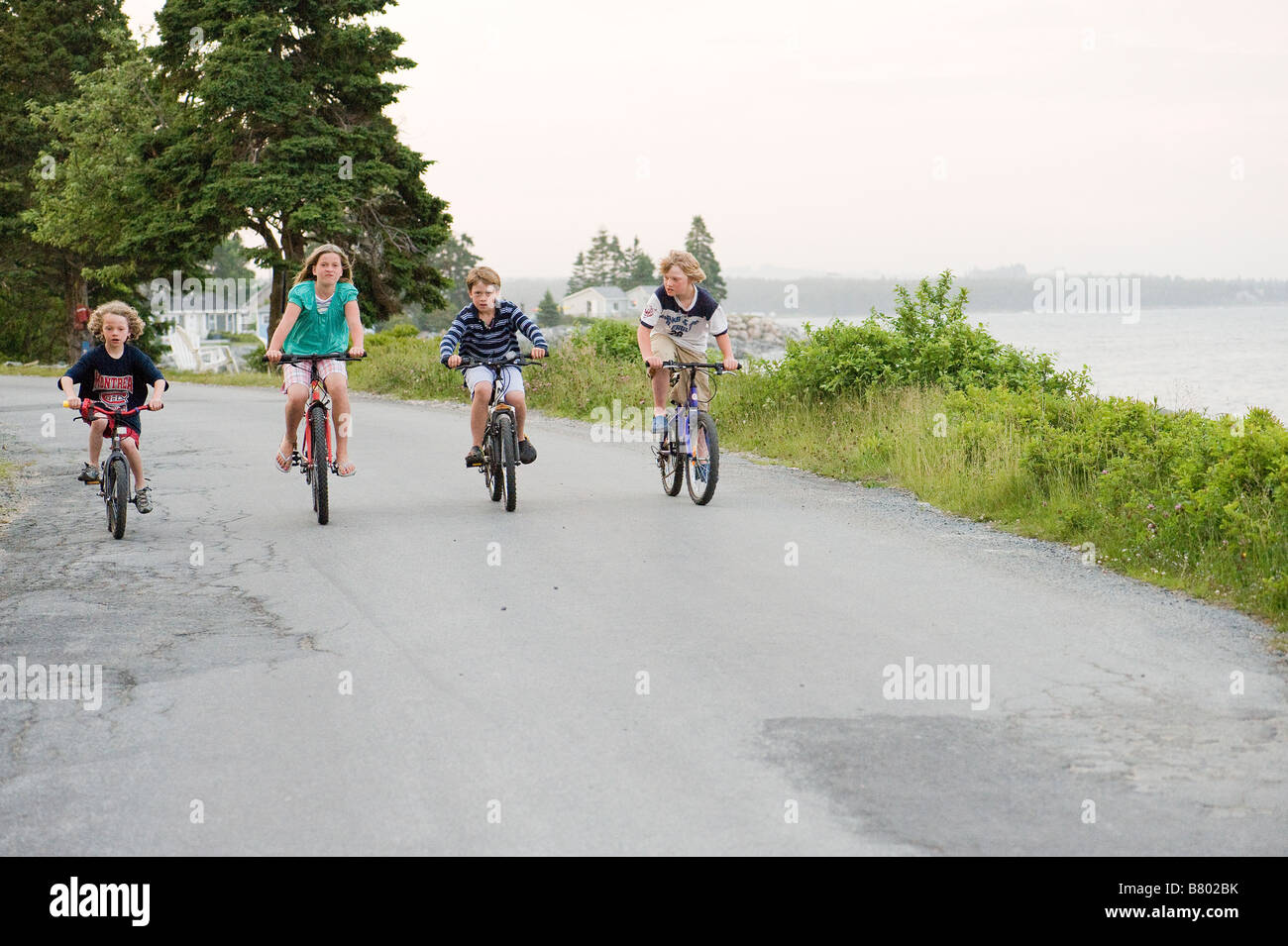 Kids riding their bikes together Stock Photo - Alamy
