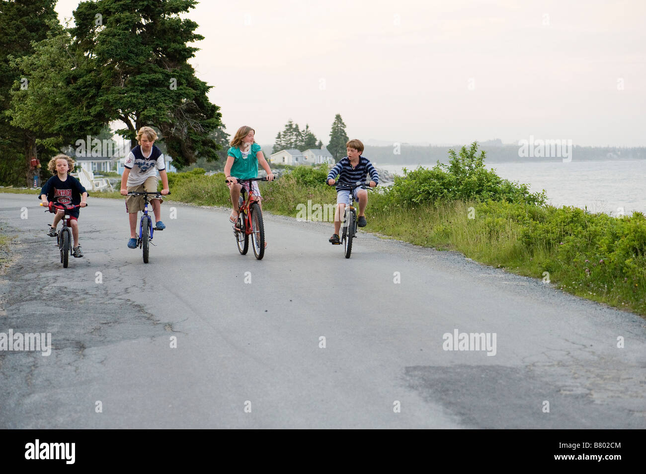 Kids riding their bikes together Stock Photo - Alamy