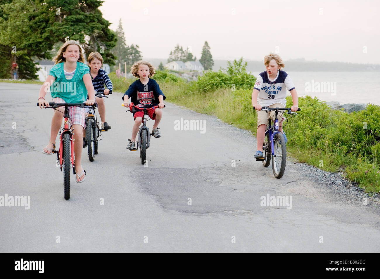 Kids riding their bikes together Stock Photo - Alamy