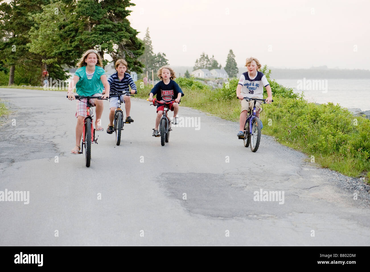 Kids riding their bikes together Stock Photo - Alamy