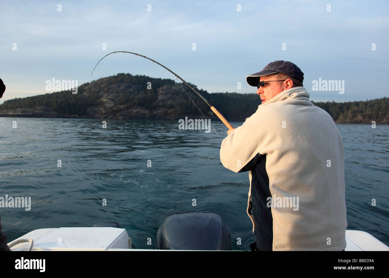 reeling in a salmon Stock Photo - Alamy