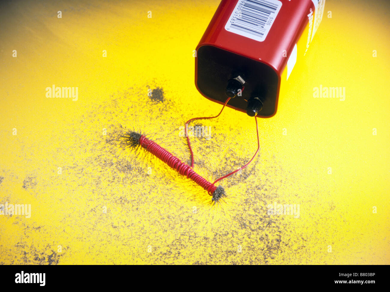Electromagnet made by wrapping wire around steel nail connected to ...