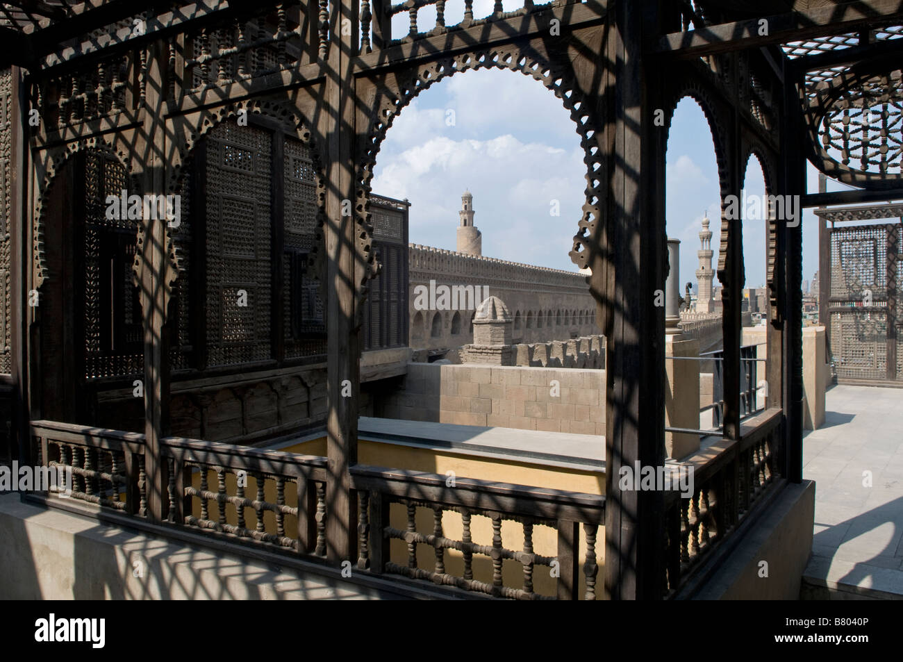 View of Ibn Tulun mosque through carved wood latticework Mashrabiya ...