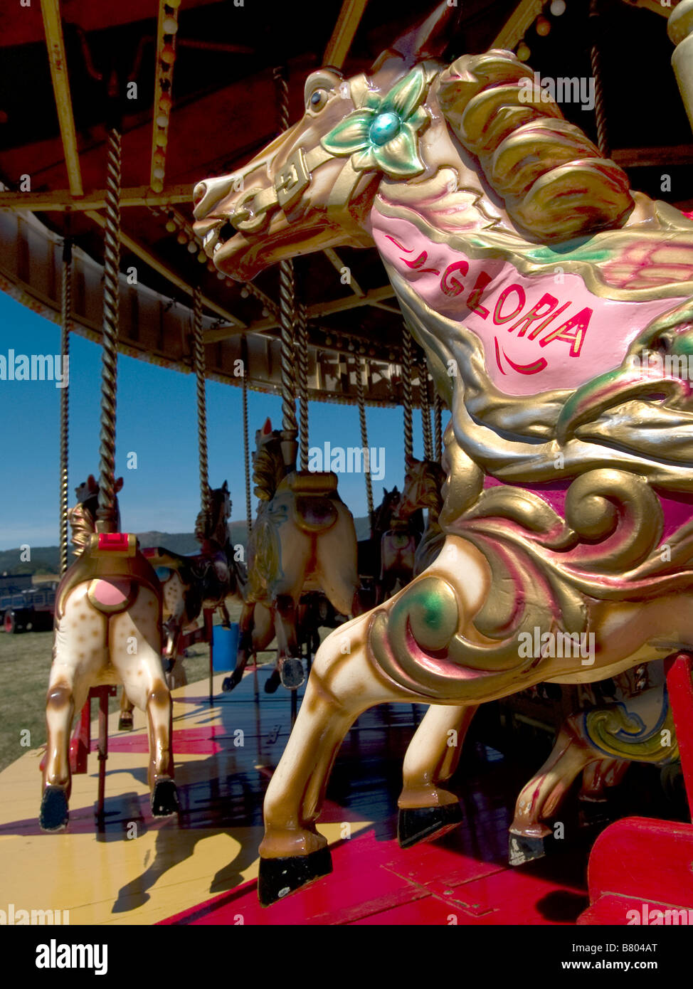 traditional roundabout or carousel with carved and painted wooden ...