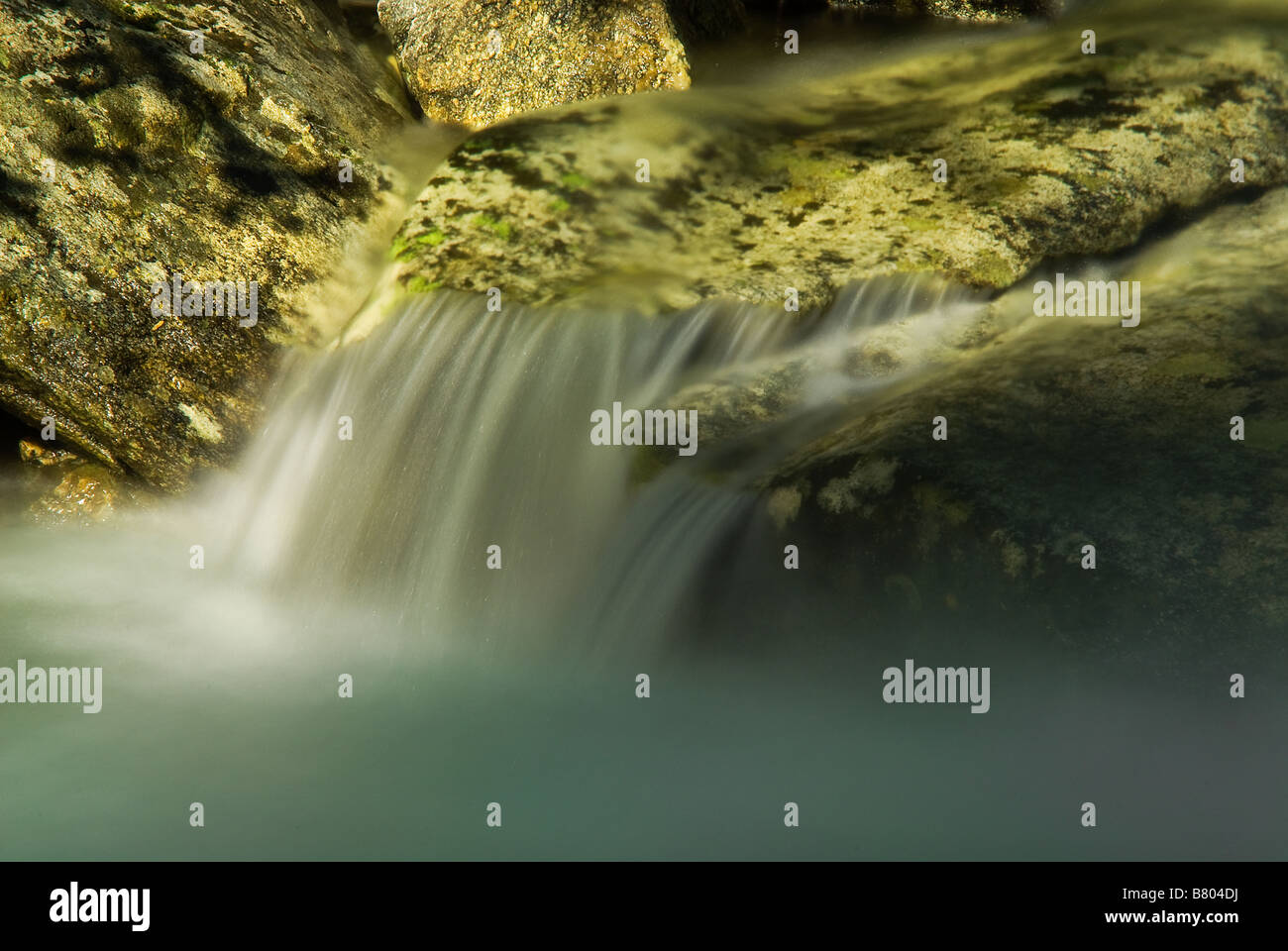 Beautiful image of water streaming down a small rock in a river Stock ...
