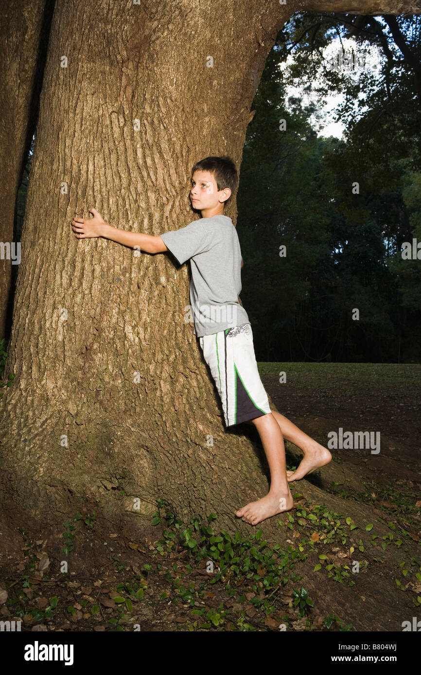 Boy hugging tree Stock Photo - Alamy