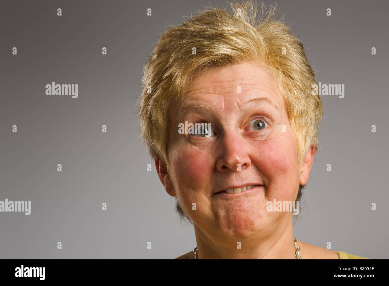 Mature woman with dazed facial expression Stock Photo - Alamy