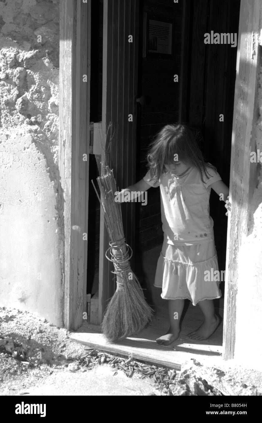 young girl sweeping the step of a old house Stock Photo - Alamy