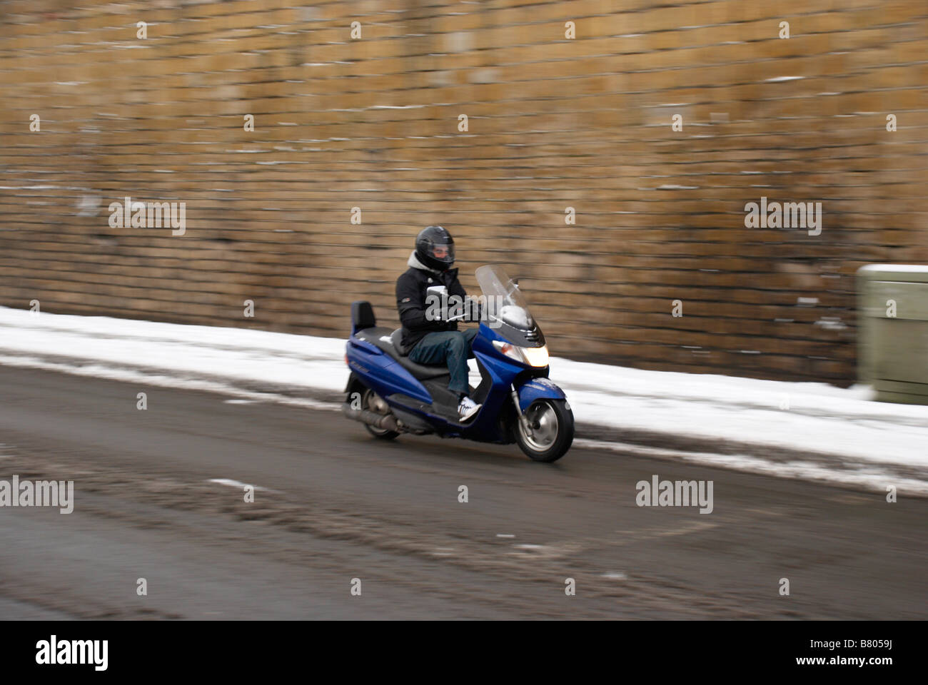 moped / scooter rider in the snow Stock Photo - Alamy