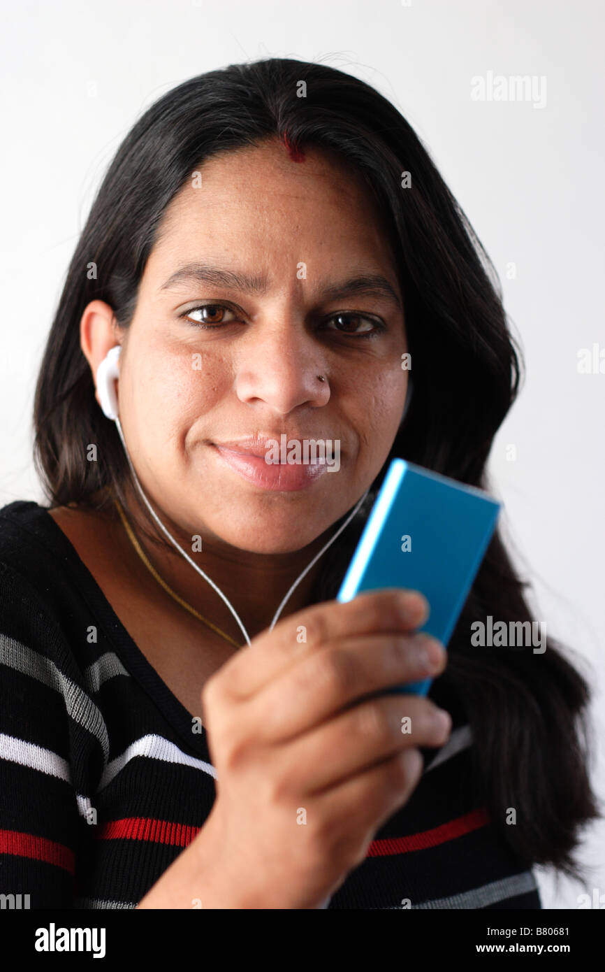 Asian Hindu woman listening to music from an iPod Stock Photo - Alamy