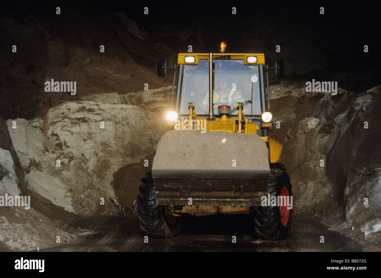 digger loading rock salt for road gritting Stock Photo - Alamy