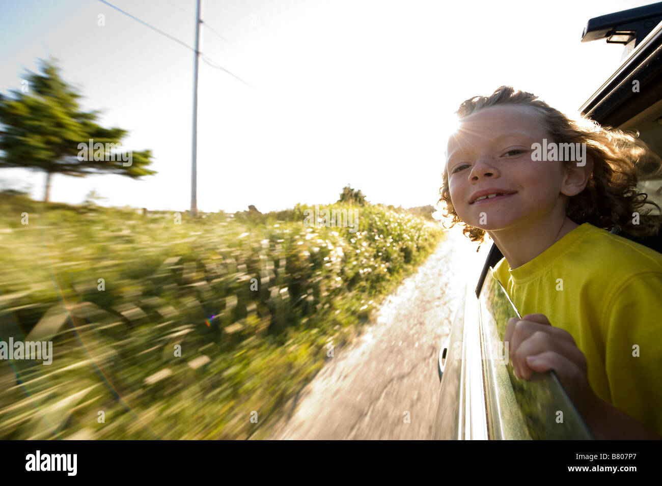 A young boy sticks his head out of the window during a drive Stock ...