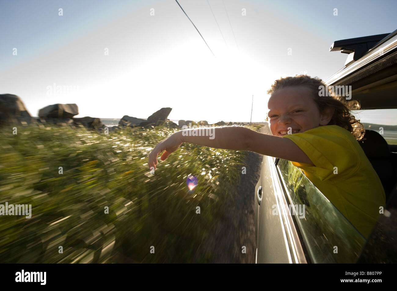 A young boy sticks his head out of the window during a drive Stock ...