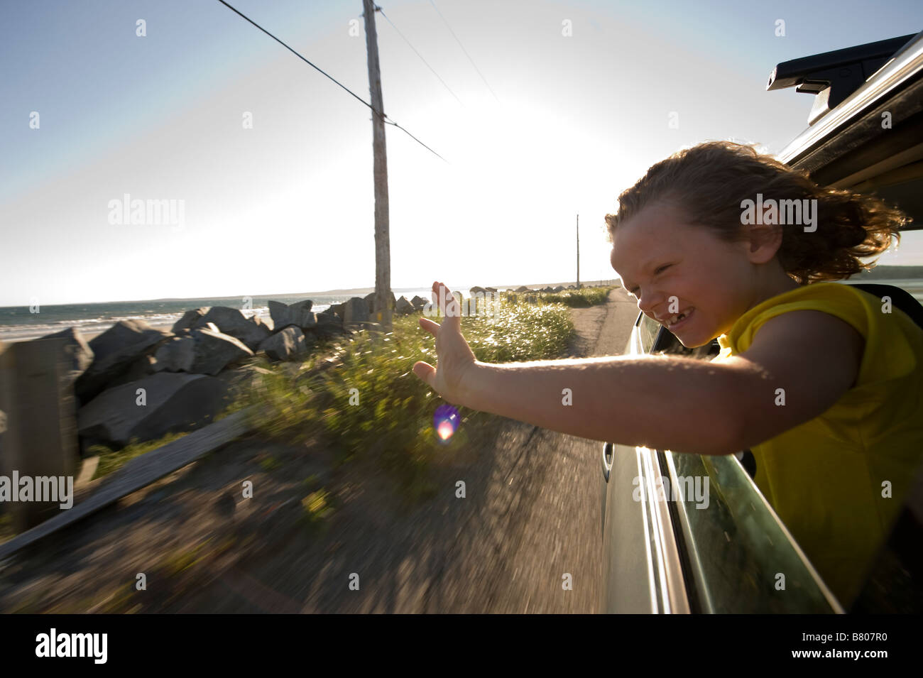 A young boy sticks his head out of the window during a drive Stock ...