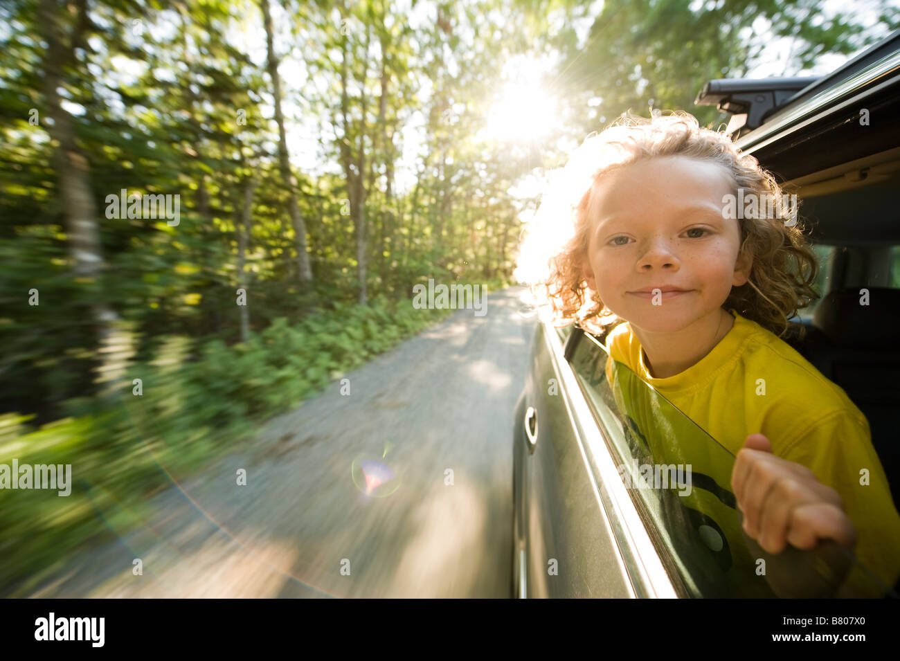A young boy sticks his head out of the window during a drive Stock ...
