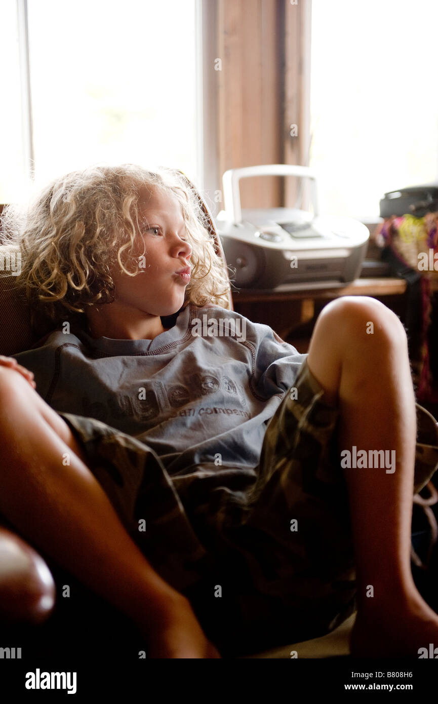 Portrait of a young boy relaxing in his home Stock Photo - Alamy