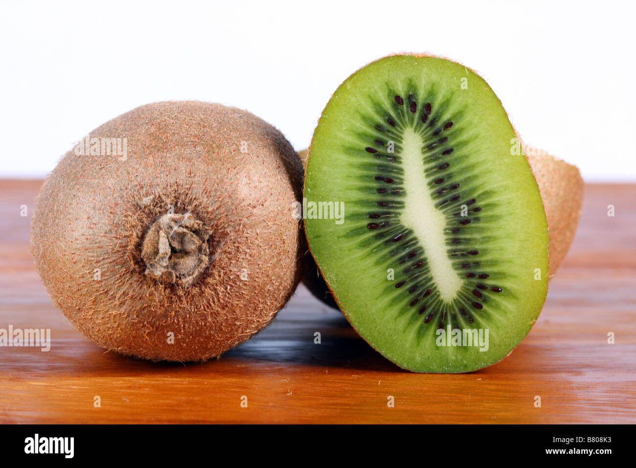 Two kiwi fruits one whole and the other cut in half Stock Photo - Alamy