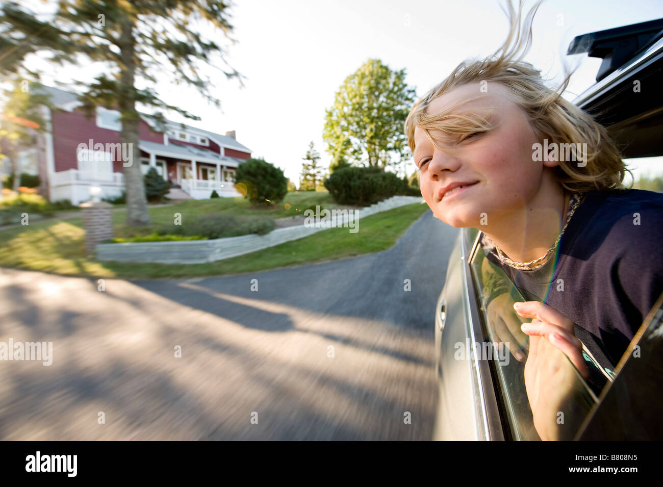 A young boy sticks his head out of the window during a drive Stock ...