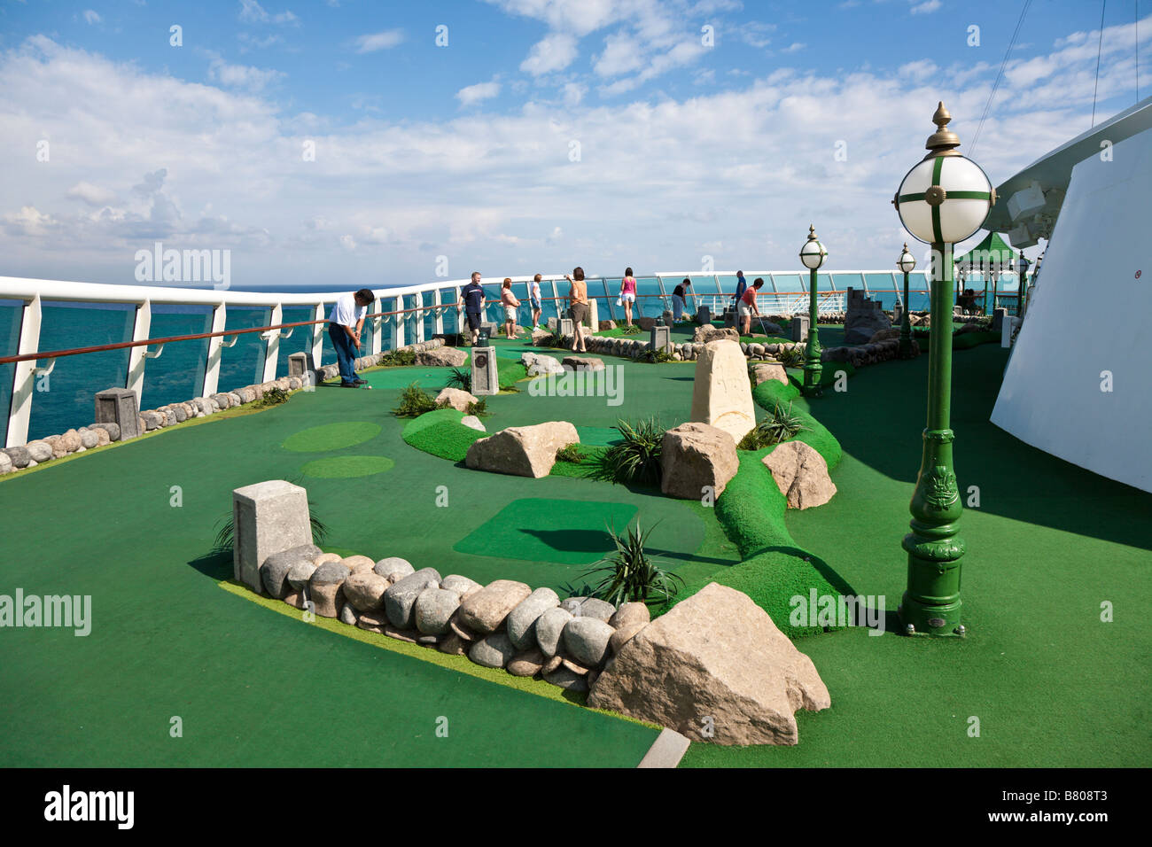 Cruise guests play miniature golf on the deck of the Royal Caribbean ...