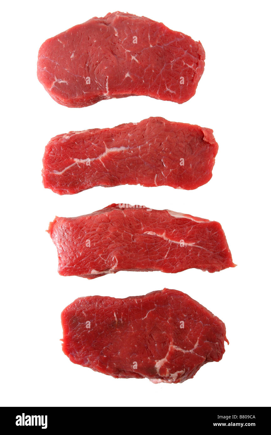 Raw red meat isolated on white four pieces of beef shot in studio Stock ...