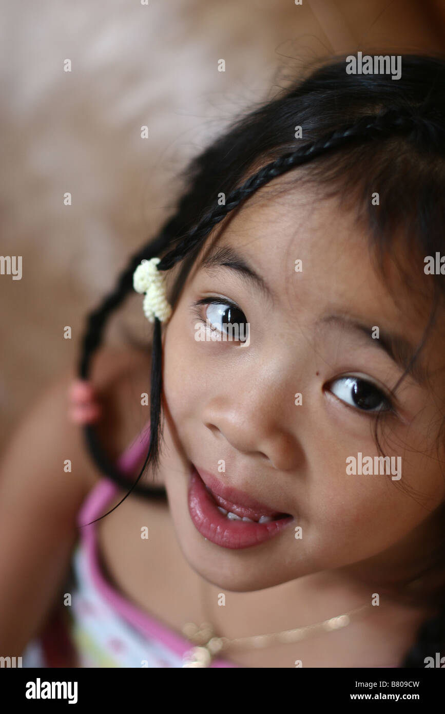close up of face of happy chinese child / girl while smiling /laughing ...
