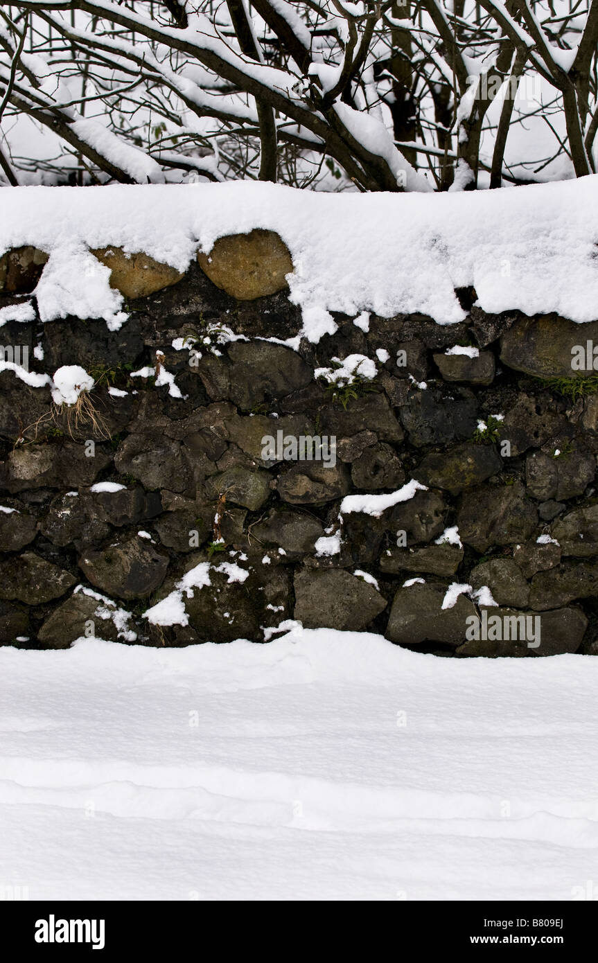 A stone wall covered in snow Stock Photo - Alamy