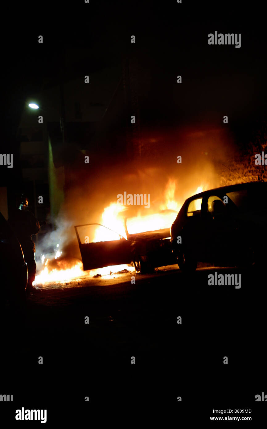 Vandalised car on fire on a urban street Stock Photo - Alamy