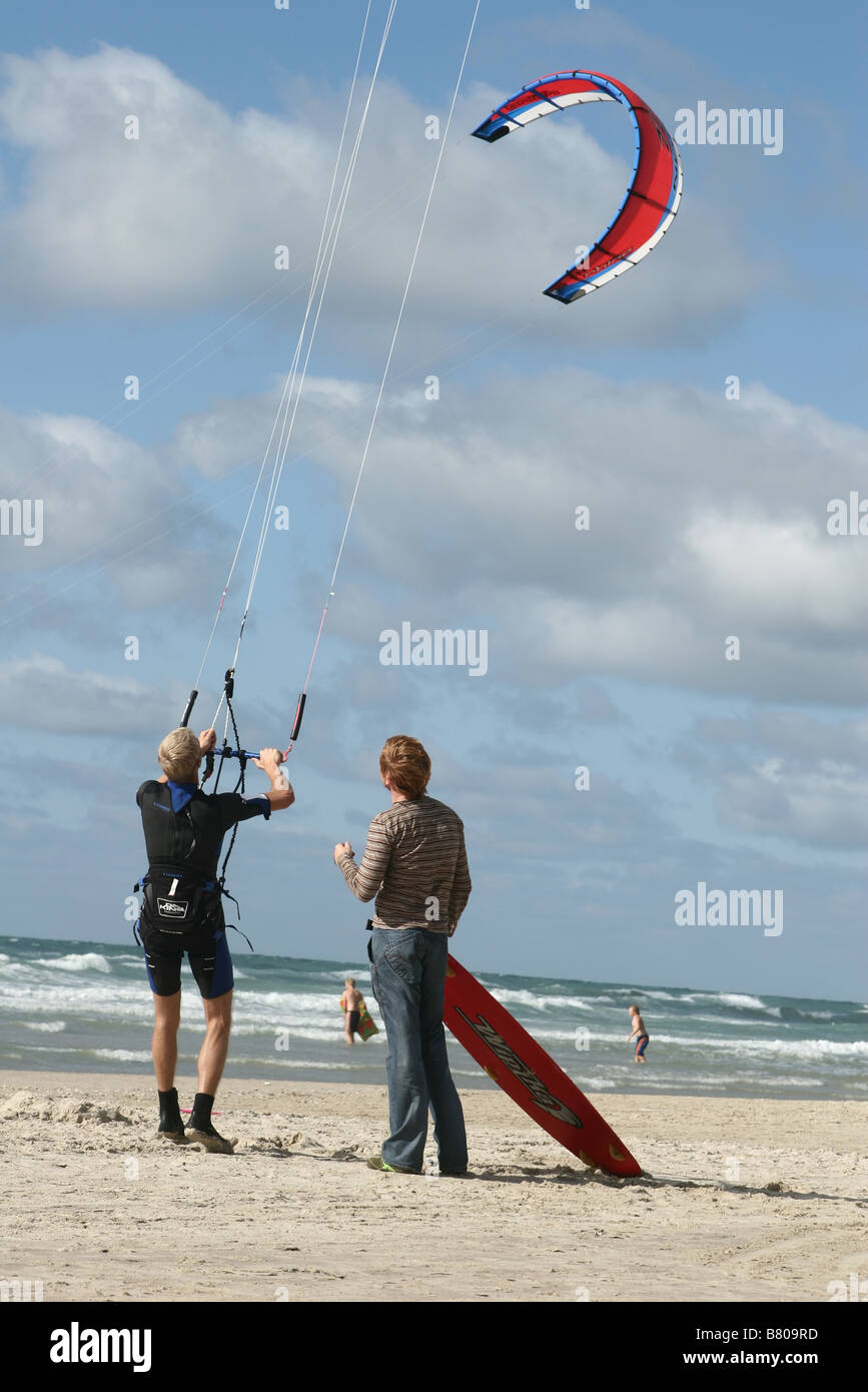 Tourists on the beach in Denmark (west coast in Loekken) Kite surfing ...
